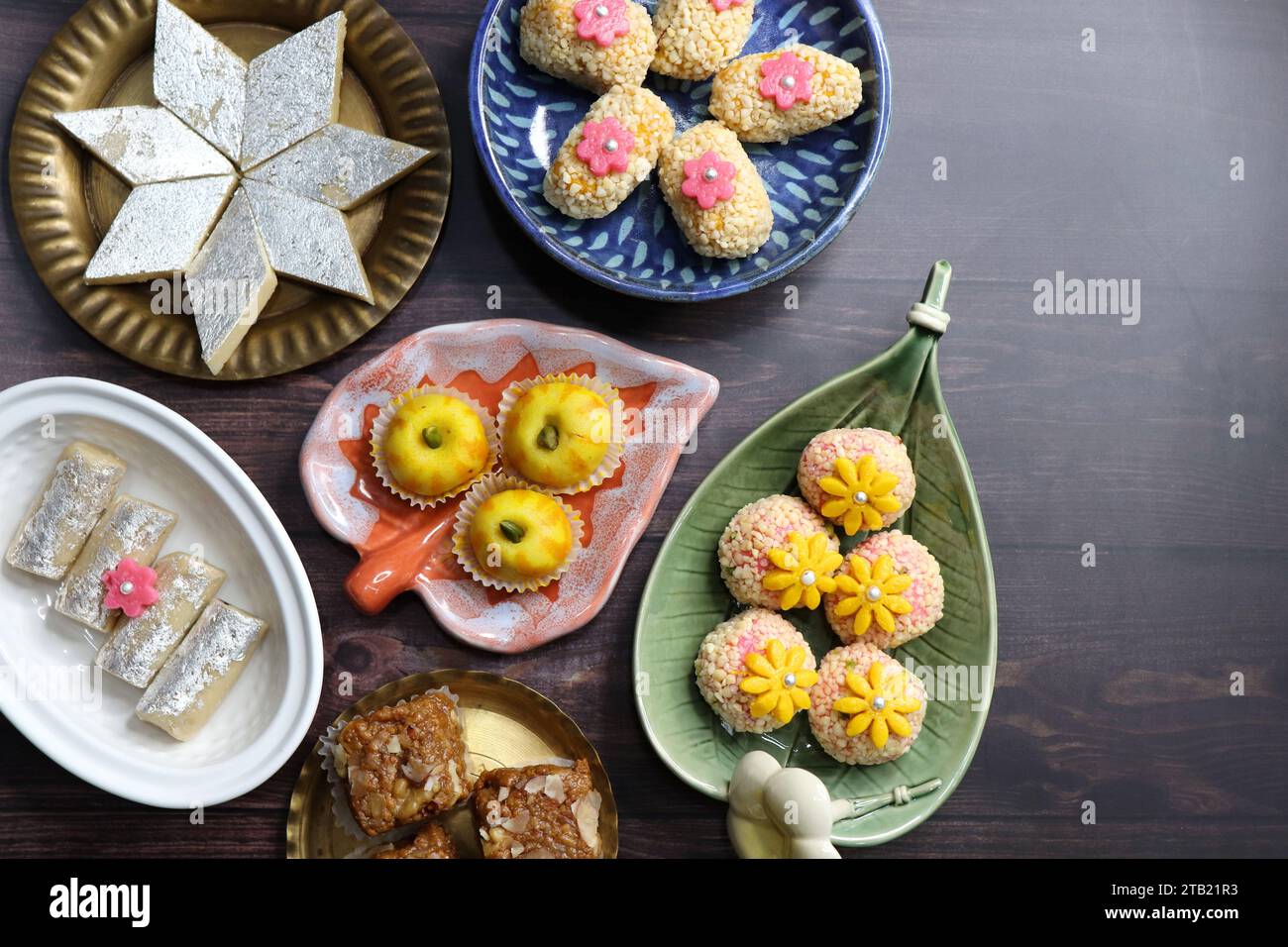 Indian assorted Diwali sweets or mithai with diya and flowers. Festive ...