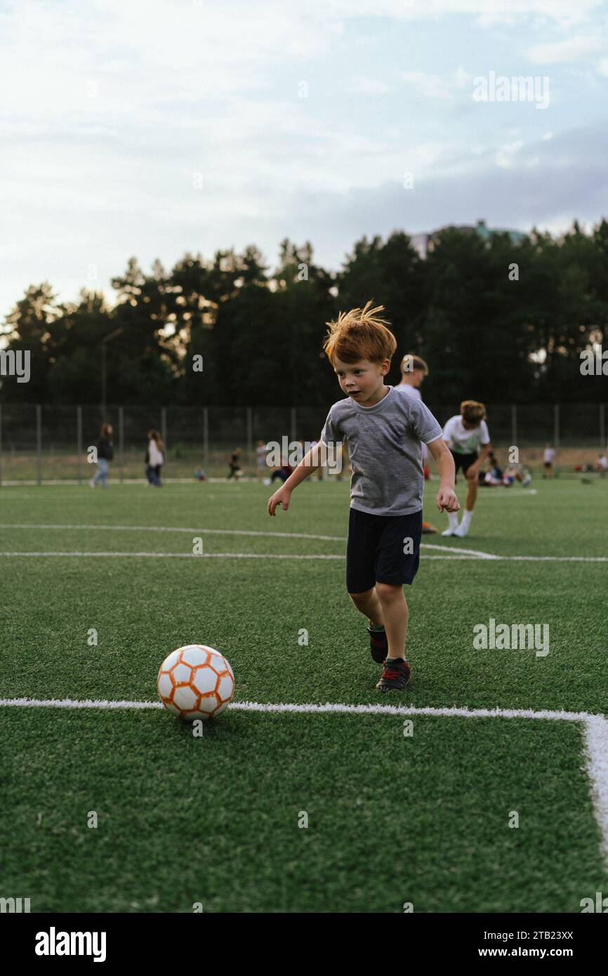 Children play football on the football field Stock Photo - Alamy