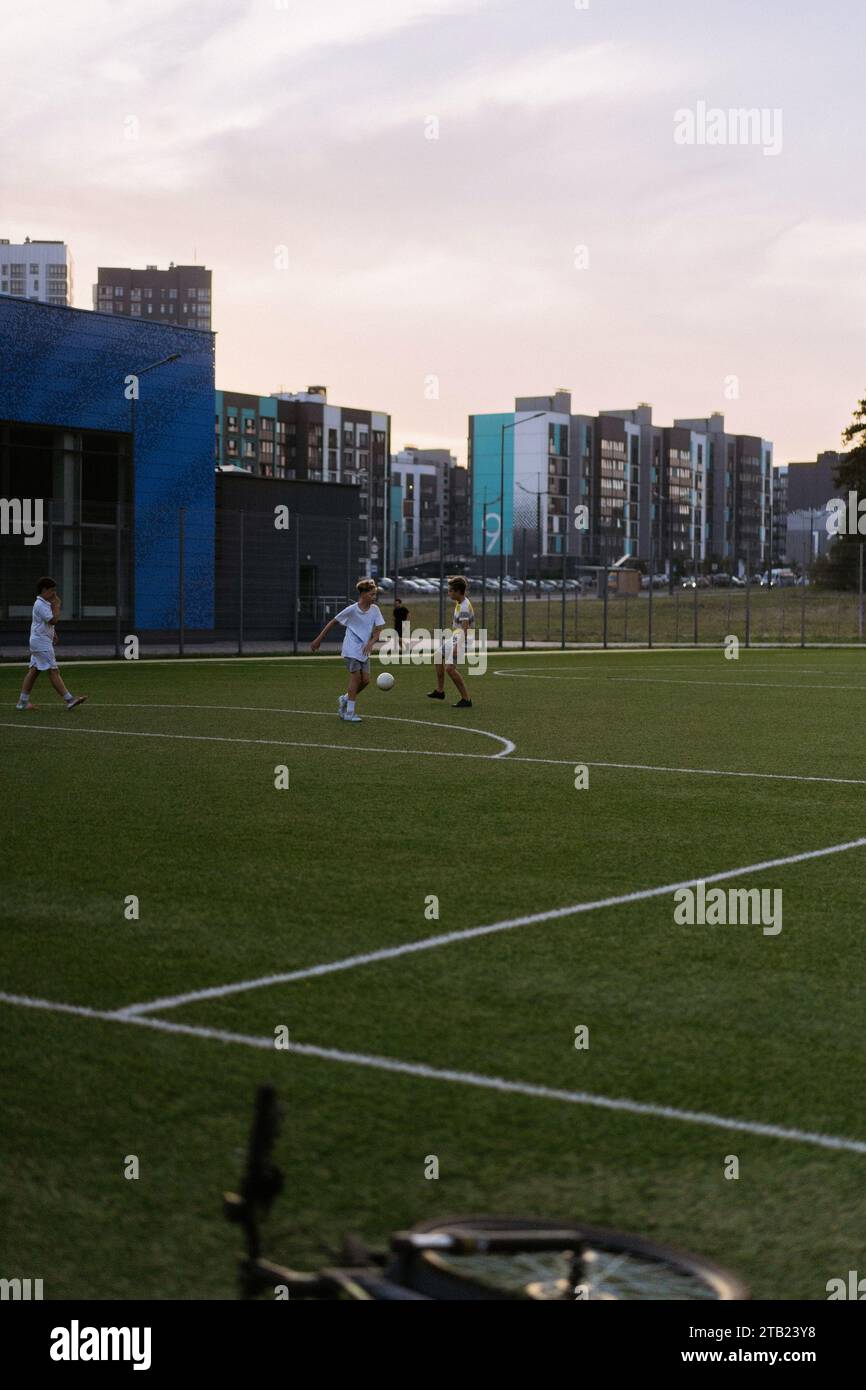 Children playing football field hi-res stock photography and images - Alamy