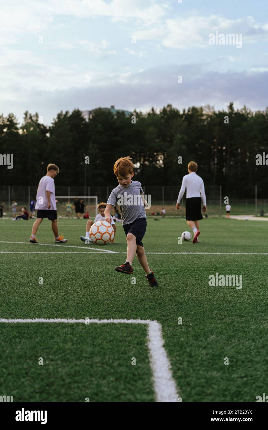 Children play football on the football field Stock Photo - Alamy