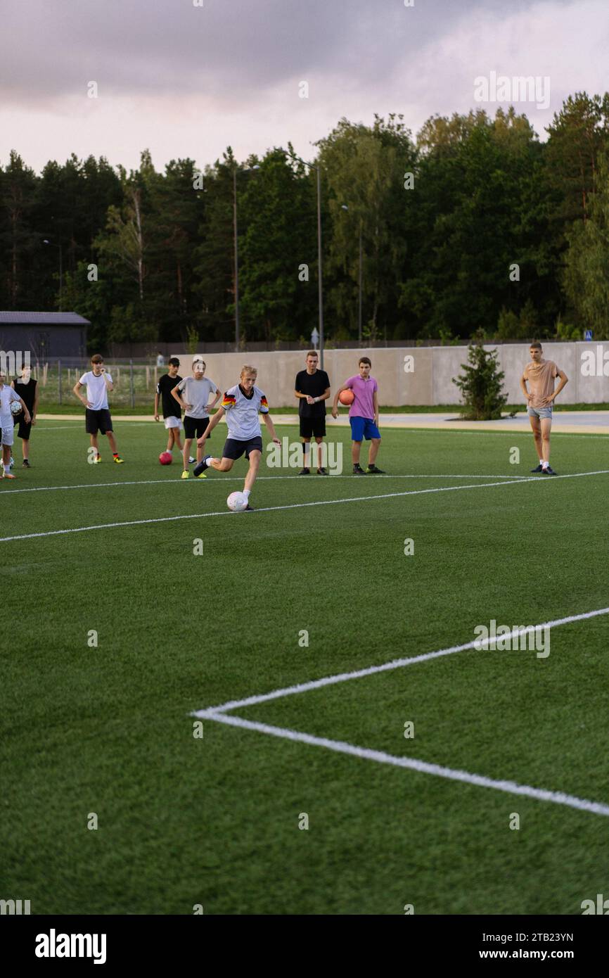 Children boys playing soccer, open school field Stock Photo - Alamy