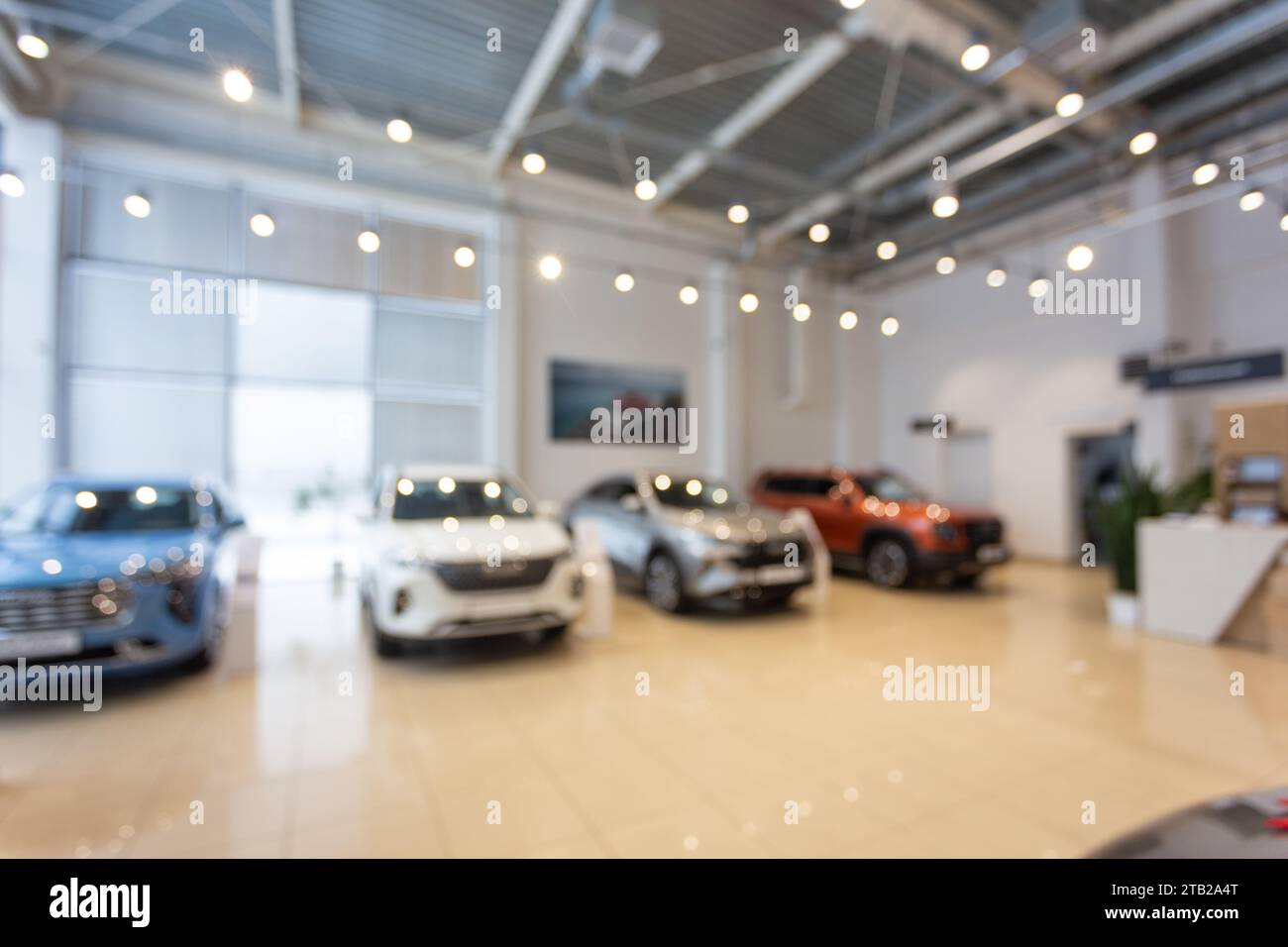 Blurred new car parked in modern showroom waiting for sales. Abstract ...