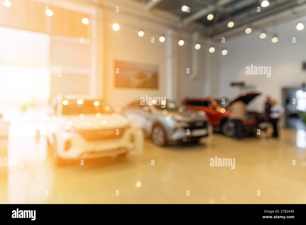 Blurred new car parked in modern showroom waiting for sales. Abstract ...