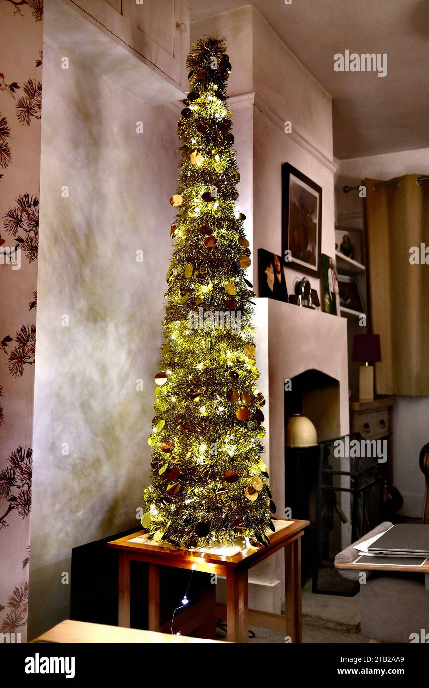 artificial gold christmas tree decorates a lounge in residential home ...
