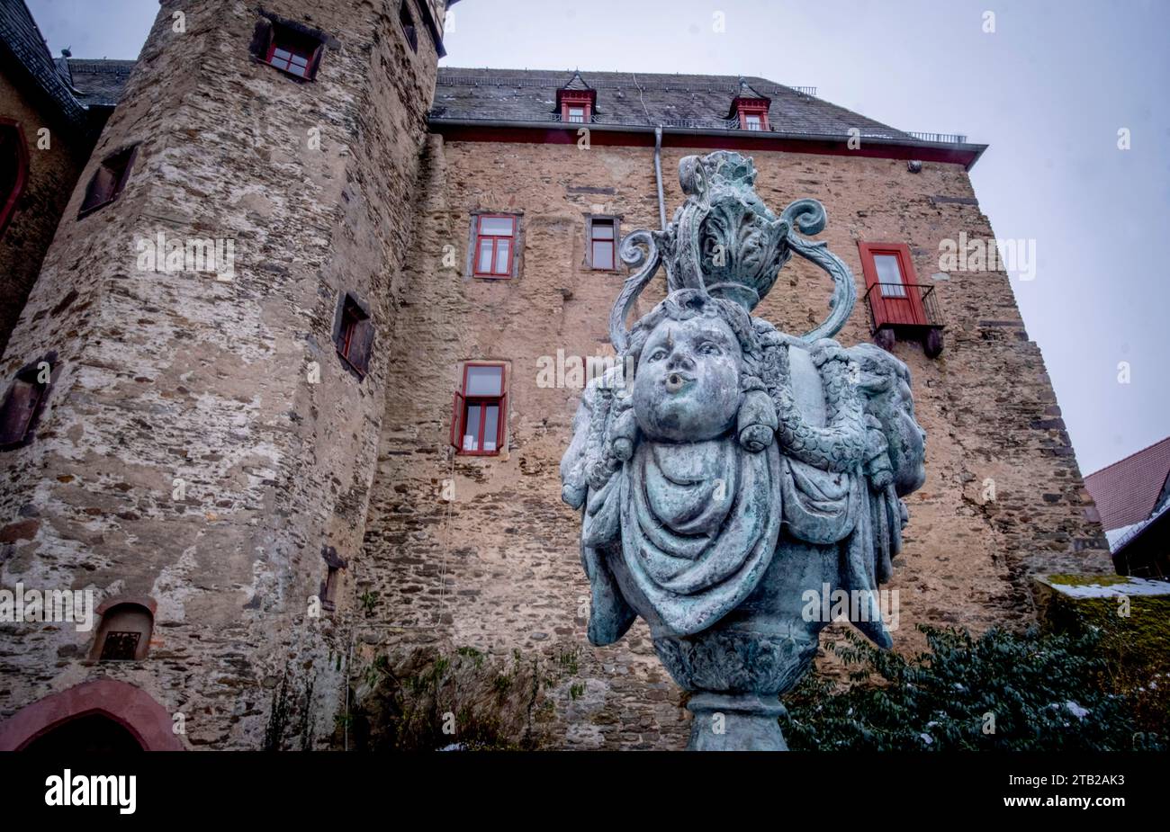 A fountain stands in front of Kransberg Castle in the village of ...