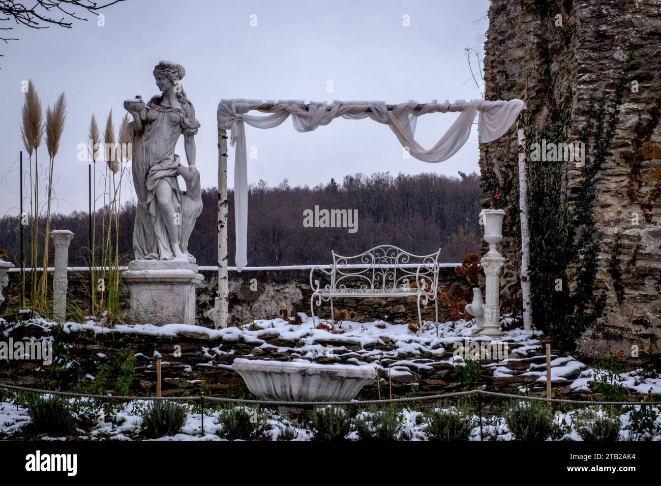 A statue stands in the garden of Kransberg Castle in the village of ...