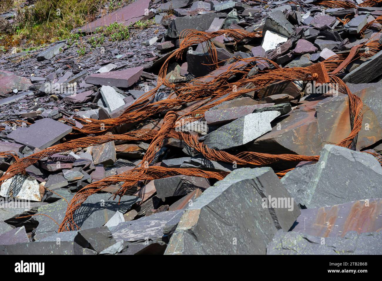 Old rusty cable on a slate slag heap at Dinorwig Quarry, Llanberis ...