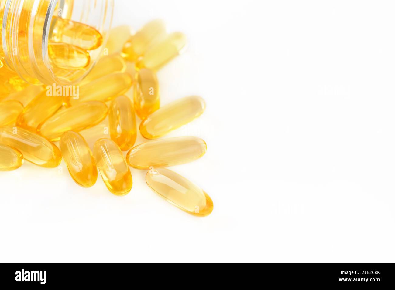 Capsules. Yellow pills isolated on white. Close up capsules with ...