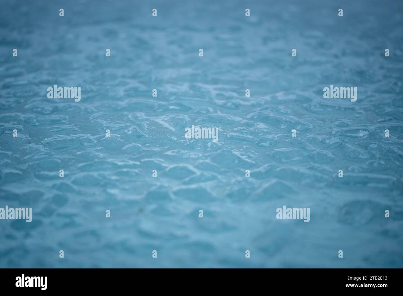 Cold water and ice cubes melting background. Global warming or climate ...