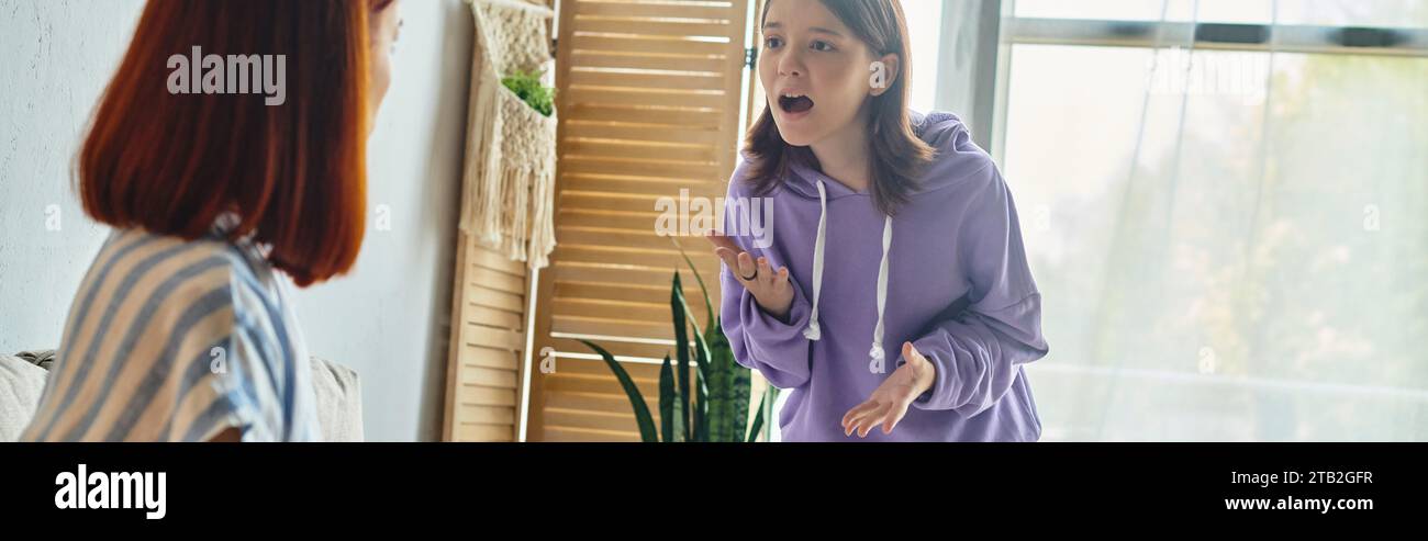 irritated teenage girl screaming and quarreling with mother at home in ...