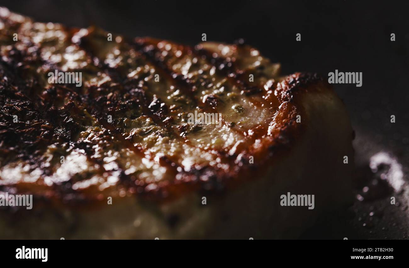 Seasoned tomahawk steak is cooked in a frying pan Stock Photo - Alamy