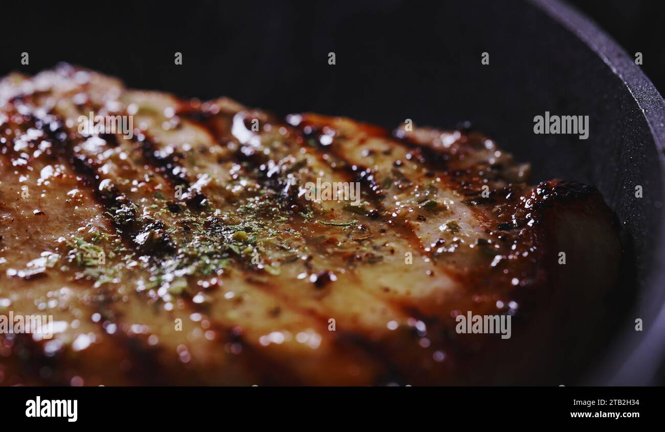 Seasoned tomahawk steak is cooked in a frying pan Stock Photo - Alamy