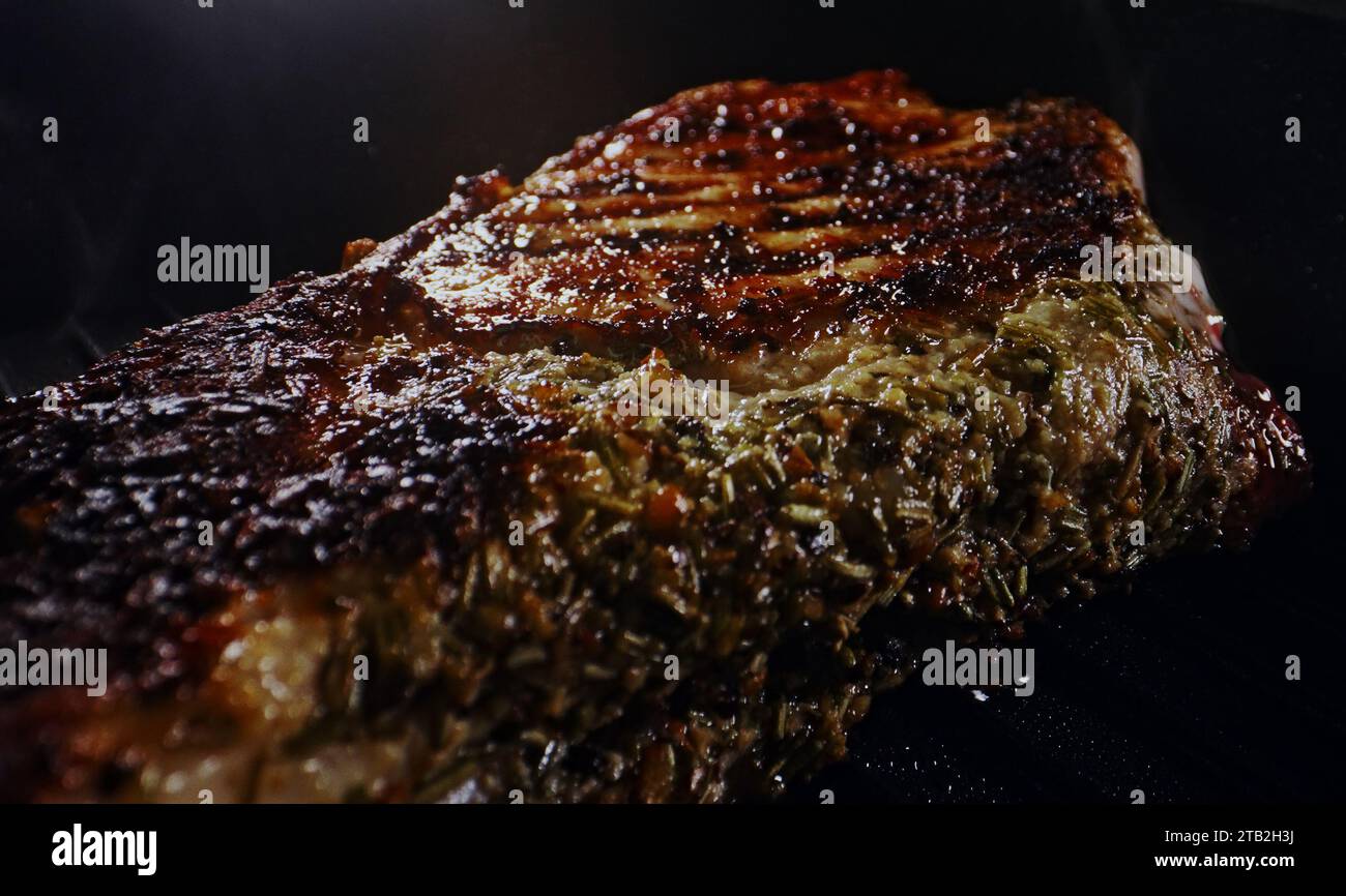 Seasoned tomahawk steak is cooked in a frying pan Stock Photo - Alamy