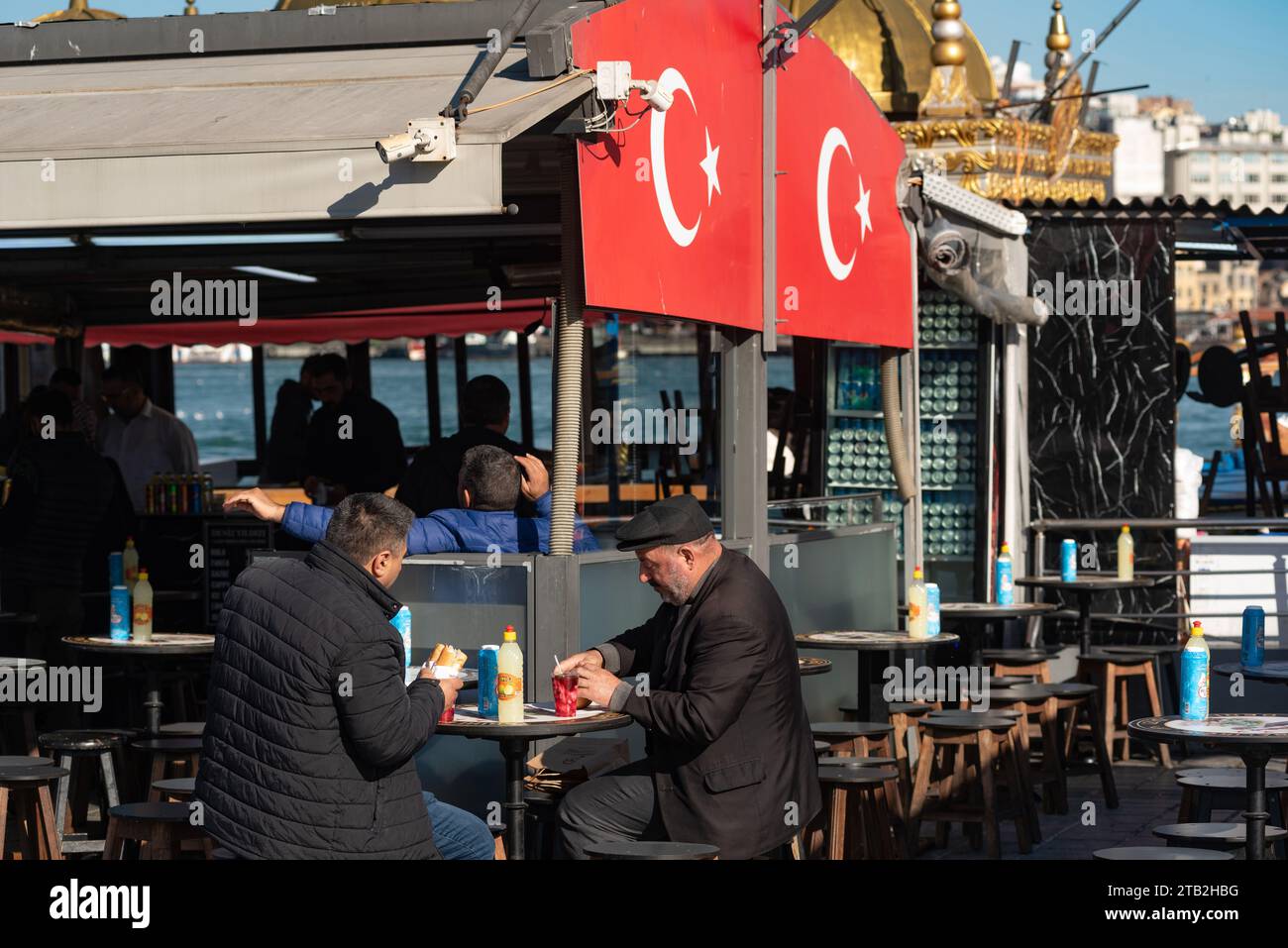 Istanbul, Turkey. November 21st 2023 Two Turkish men eat Balik Ekmek, a ...