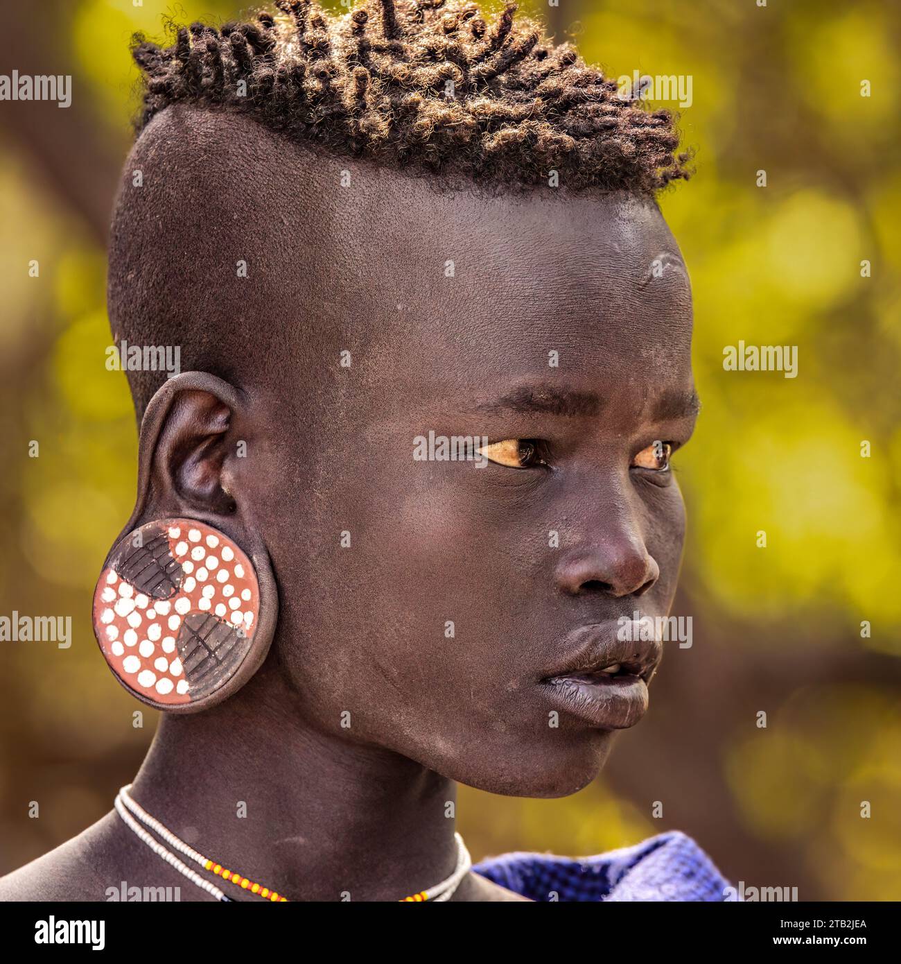 Large earrings in the Mursi Tribe Stock Photo - Alamy