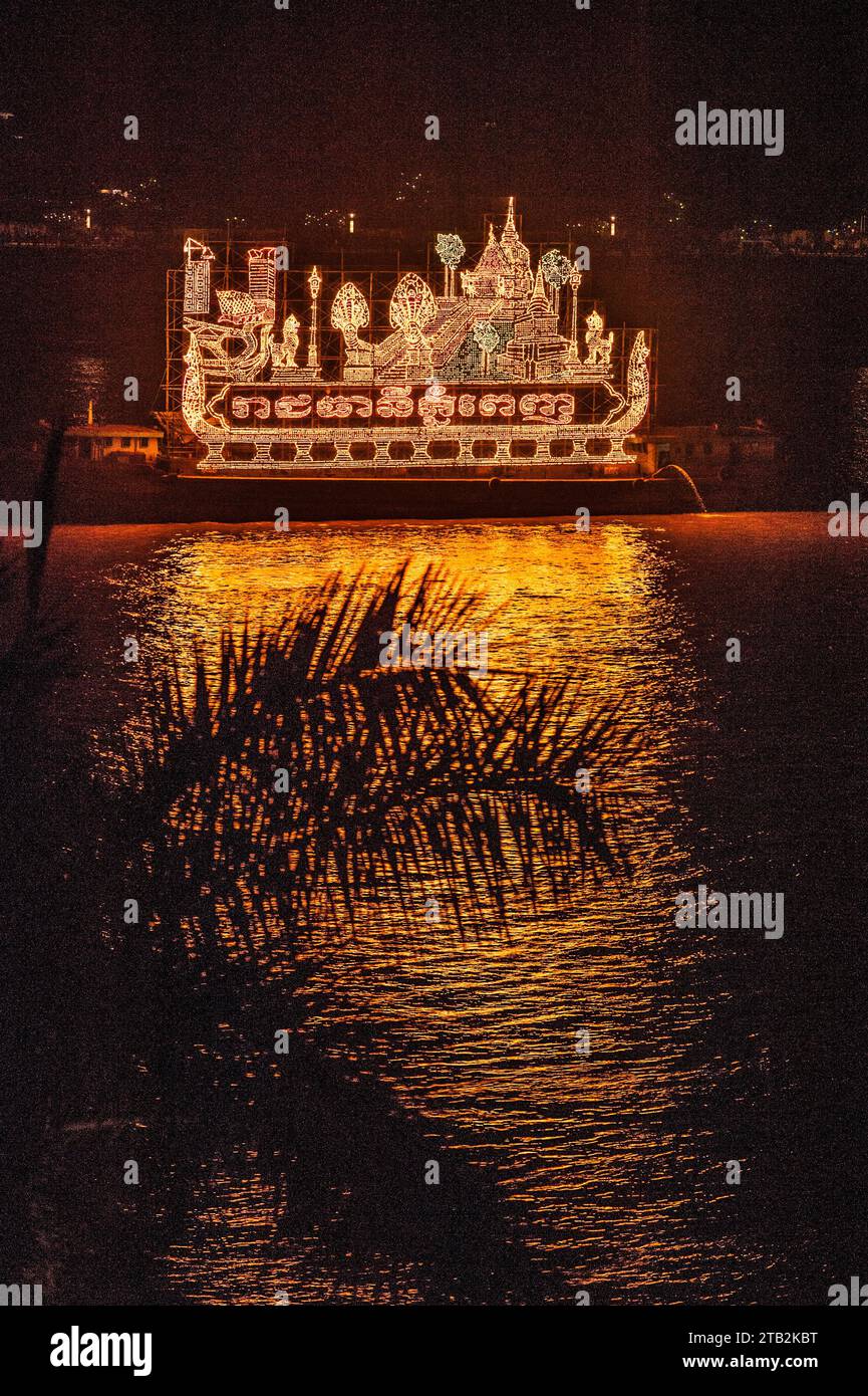 Illuminated float / barge casts its reflection on the Tonle Sap River ...