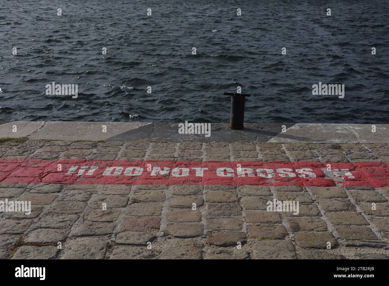 Do not cross line on coast Stock Photo - Alamy