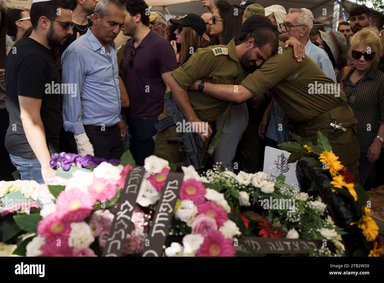 Relatives and friends of Israeli Col. Asaf Hamami mourn during his ...