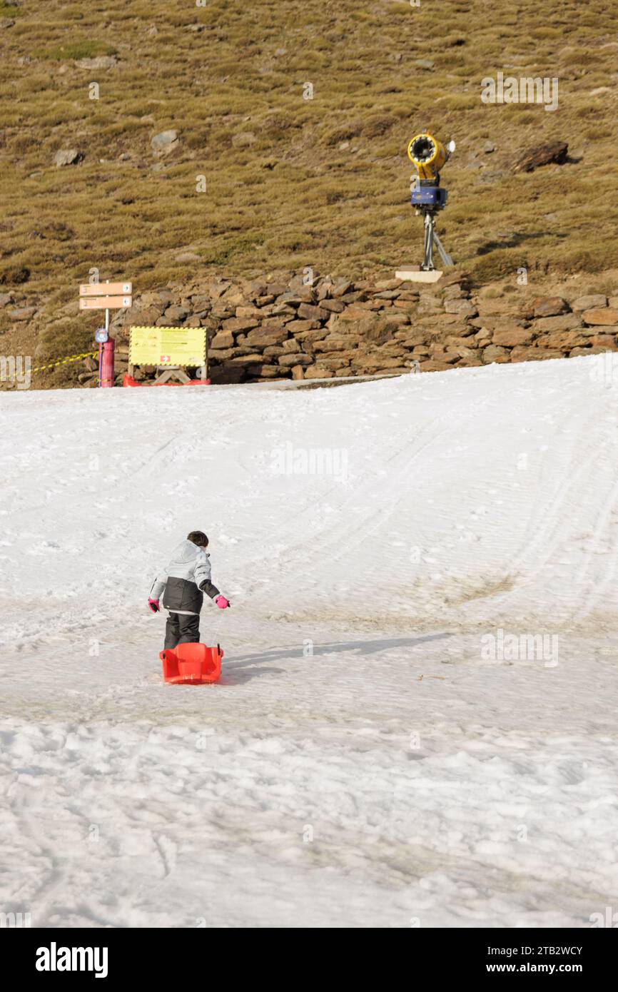 Boy pulling a sled Stock Photo - Alamy