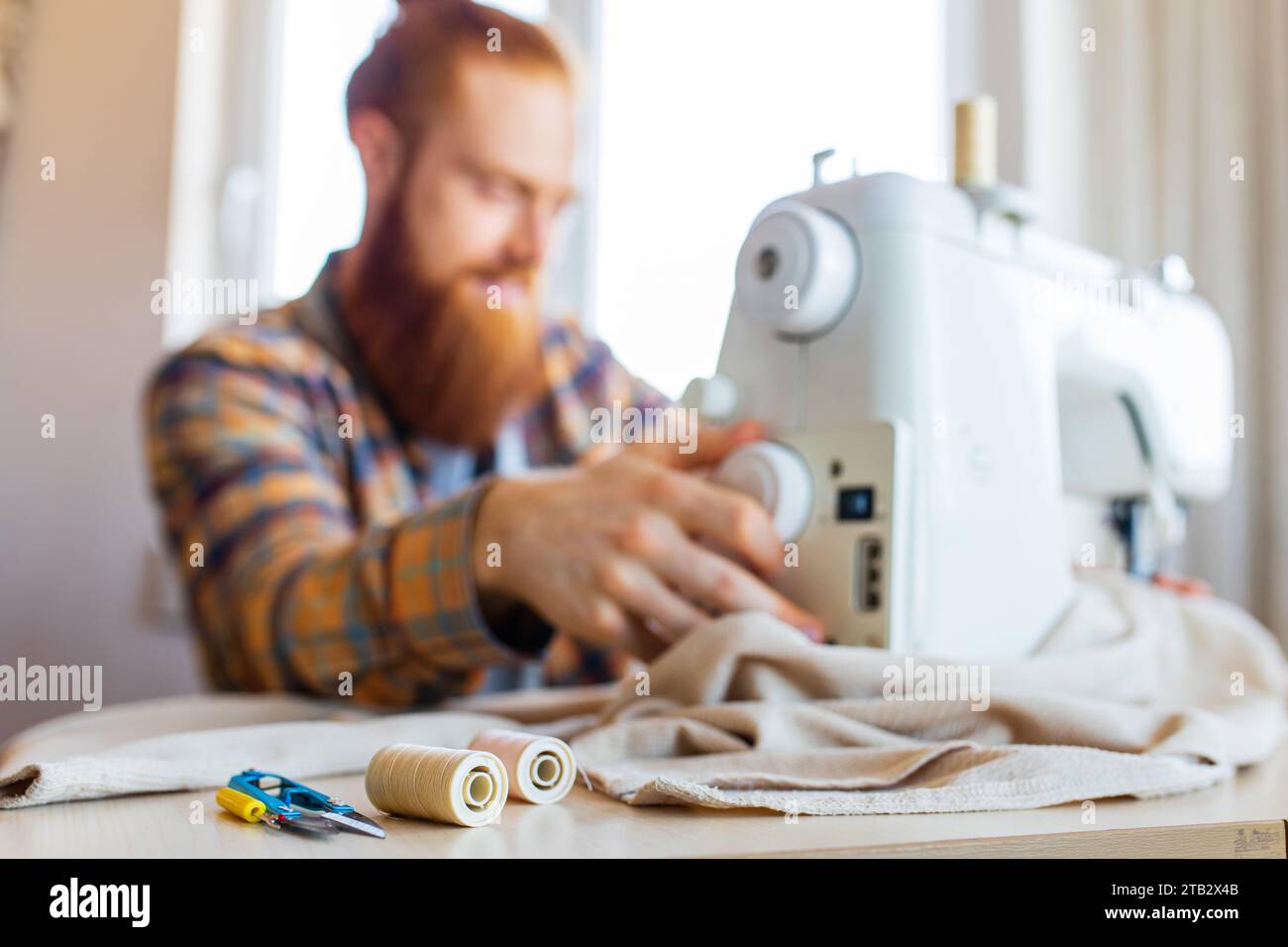 Man sews sewing machine designer hi-res stock photography and images ...