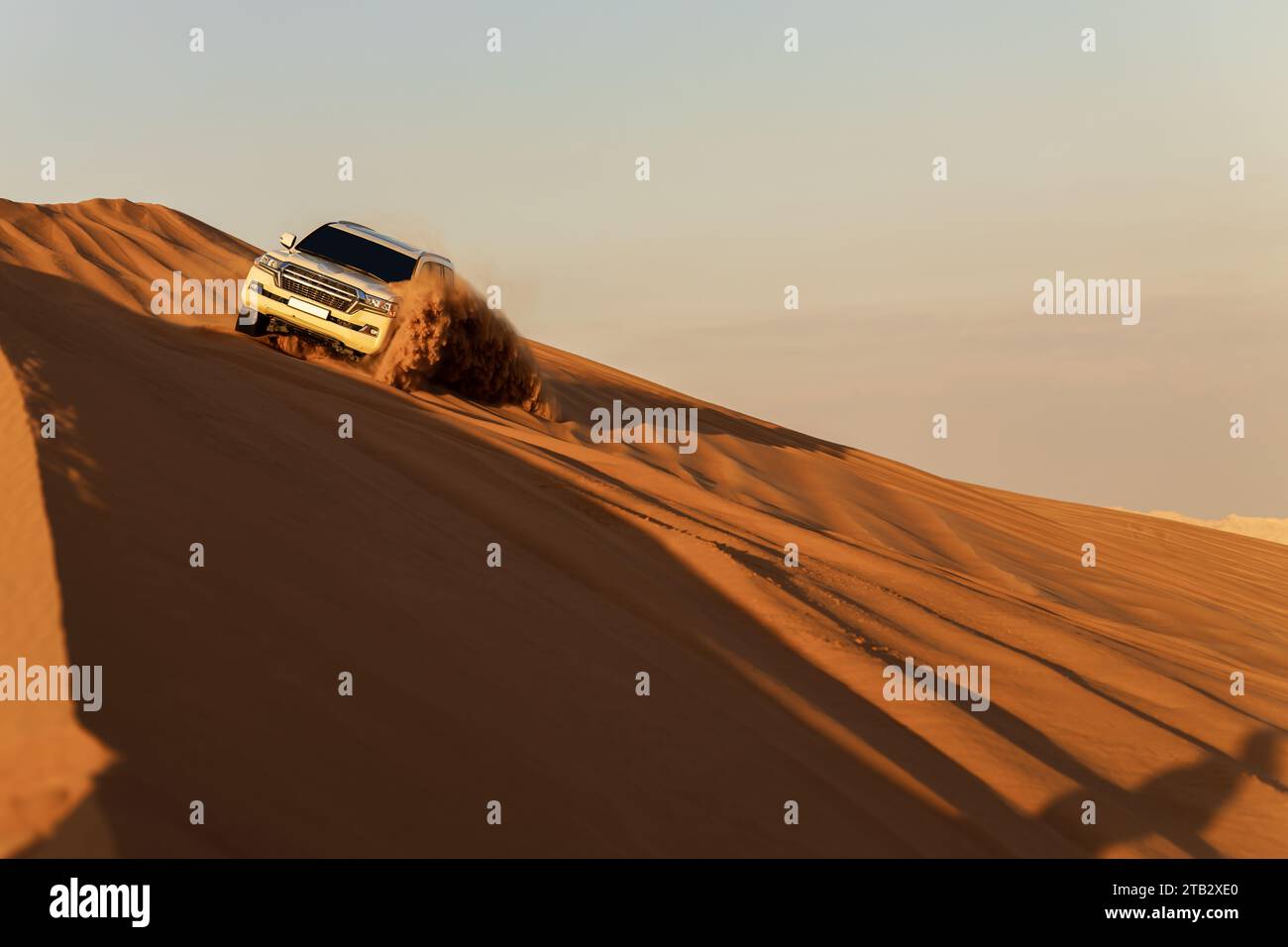 White car driving in Rub al Khali Desert at the Empty Quarter, in Abu ...