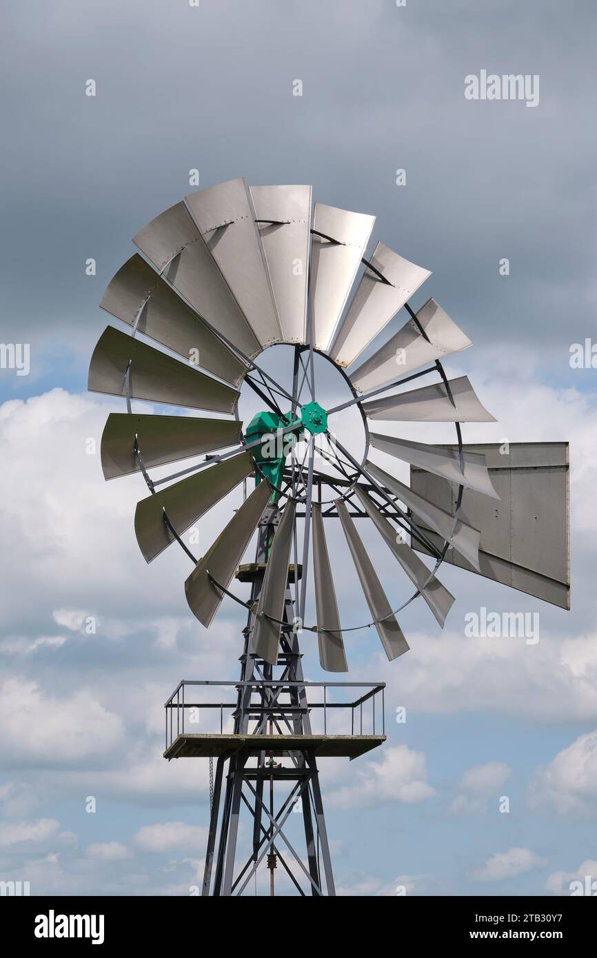 The metal blades of an american wind engine against a cloudy and stormy ...