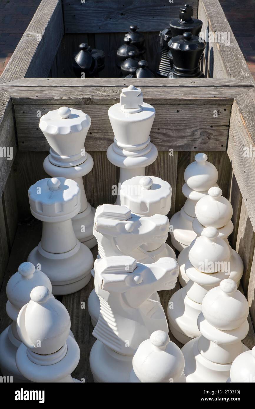 Large plastic white and black chess pieces in a wooden box for outdoor ...