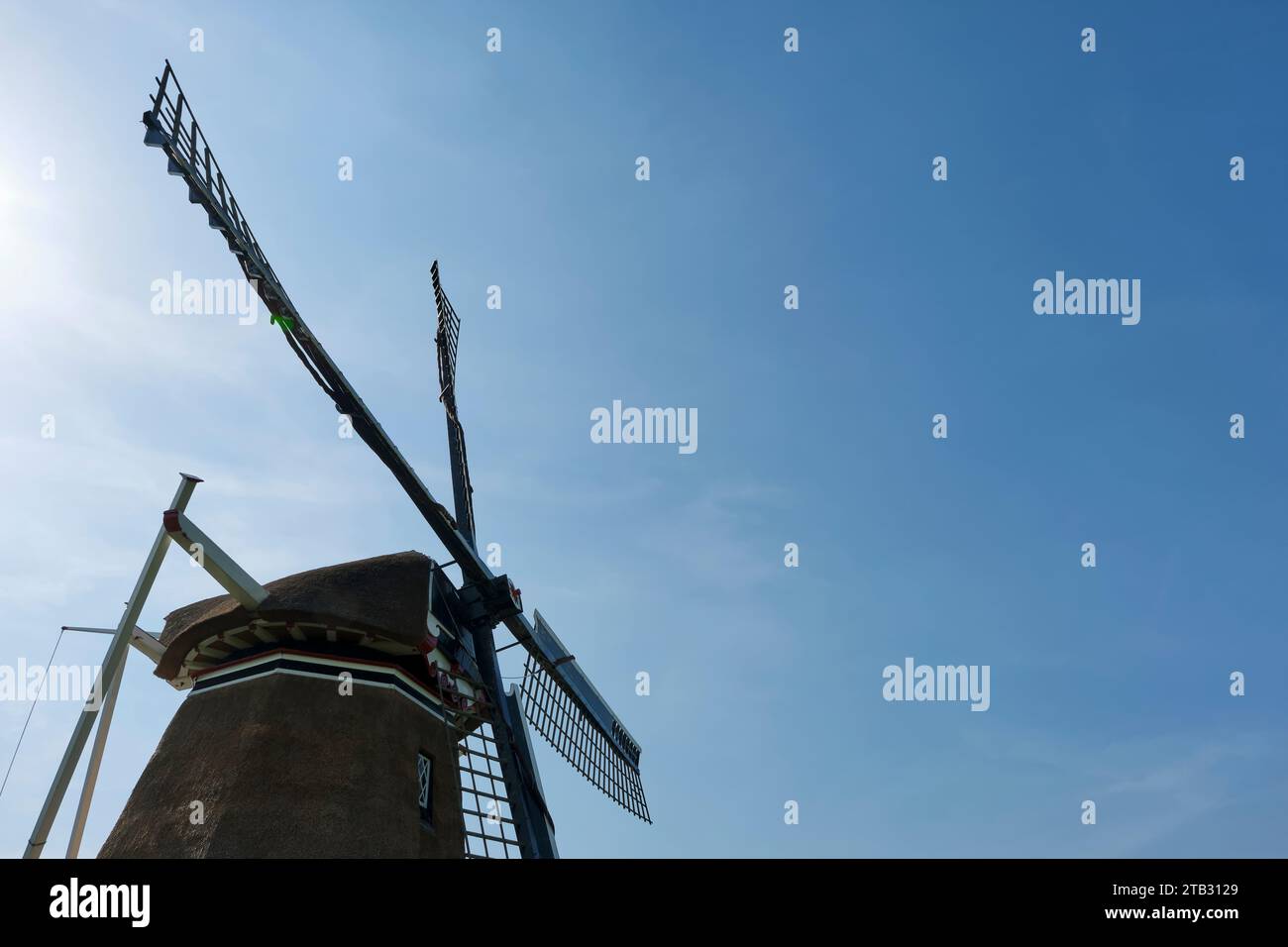Closeup of the four wings of a traditional thatched dutch windmil in ...