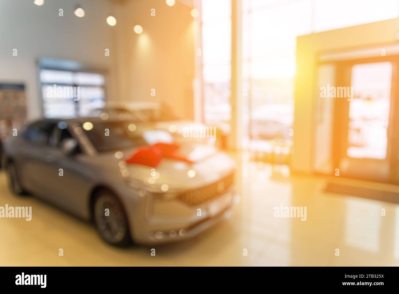Blurred new car parked in modern showroom waiting for sales. Abstract ...