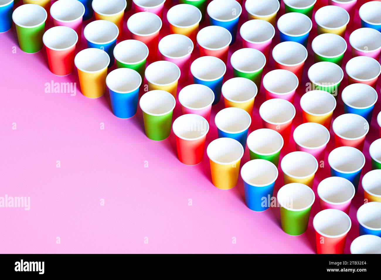 Assortment of Brightly Colored Disposable Cups on a Pastel Pink Surface ...