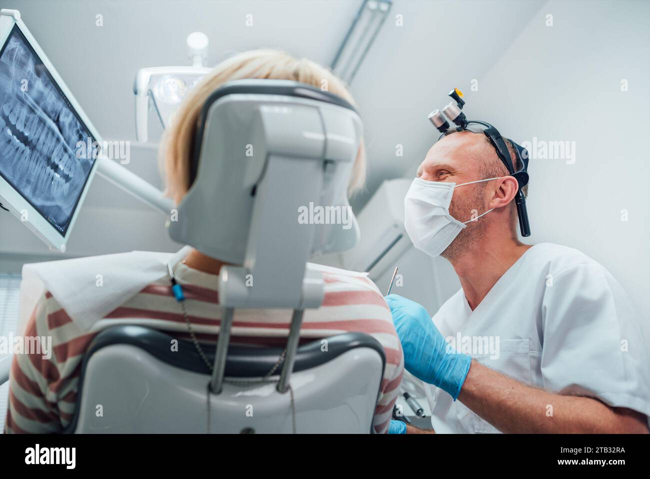 Dental clinic patient visit in modern medical ward. Dentist doctor in ...