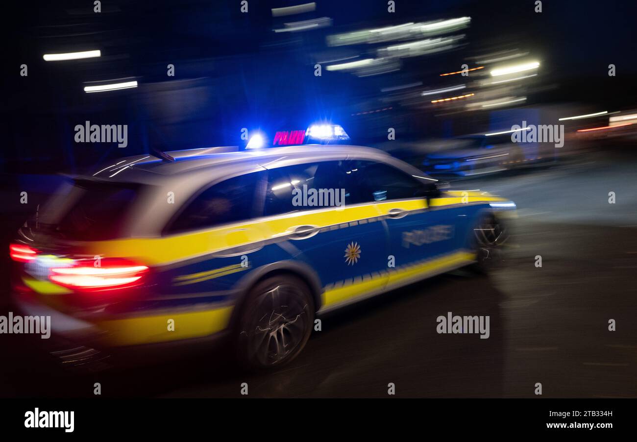 Stuttgart, Germany. 30th Nov, 2023. A police car drives past a building ...
