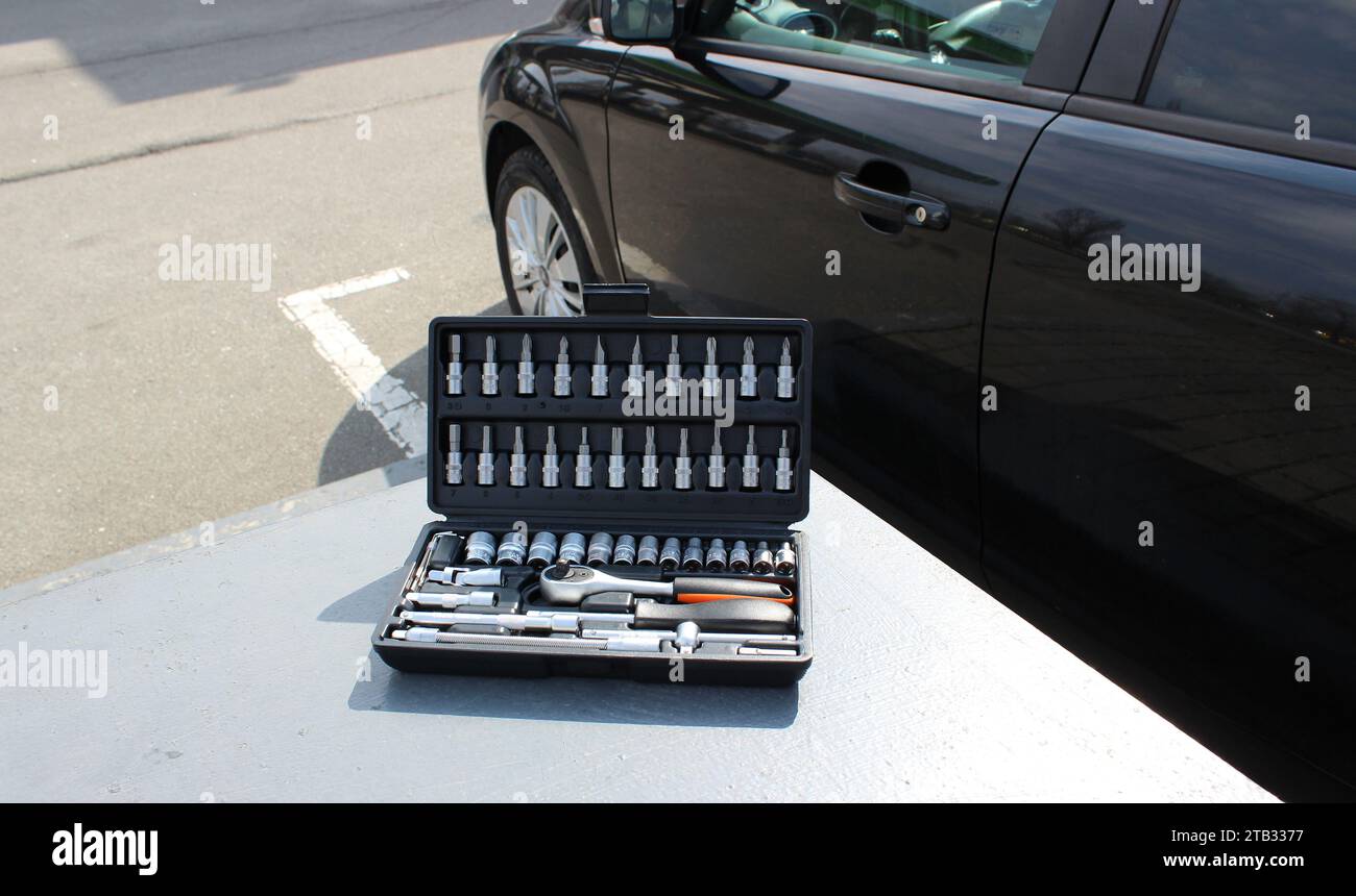 Gray Workbench With Opened Box With Mechanics Tools In Front Of Vehicle ...