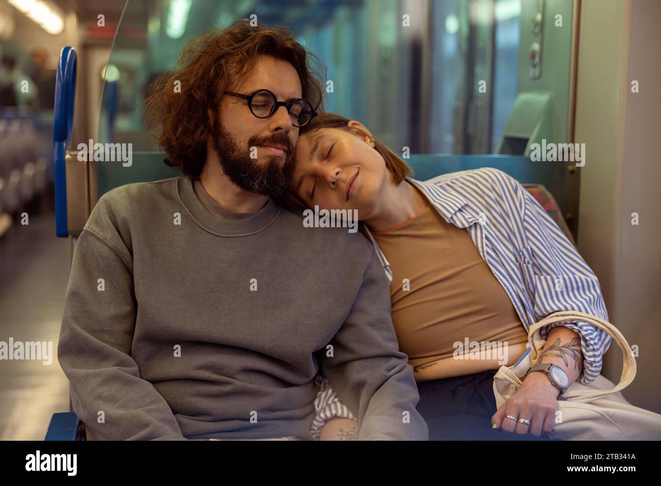 Young tired tourist couple with closed eyes is travel together while ...