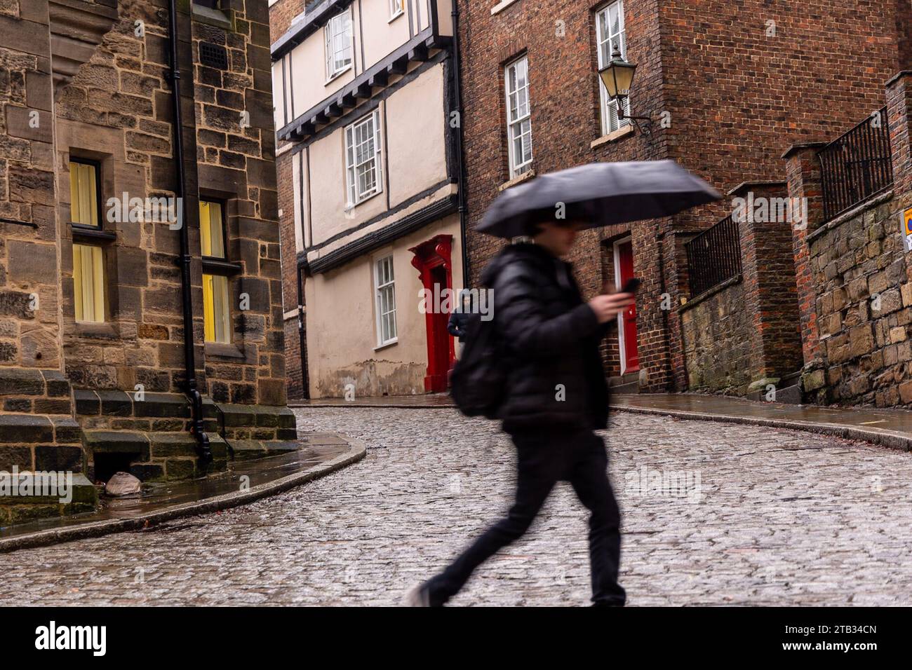 Durham, UK, 04 Dec 2023, UK Weather: Person with an umbrella passes the ...