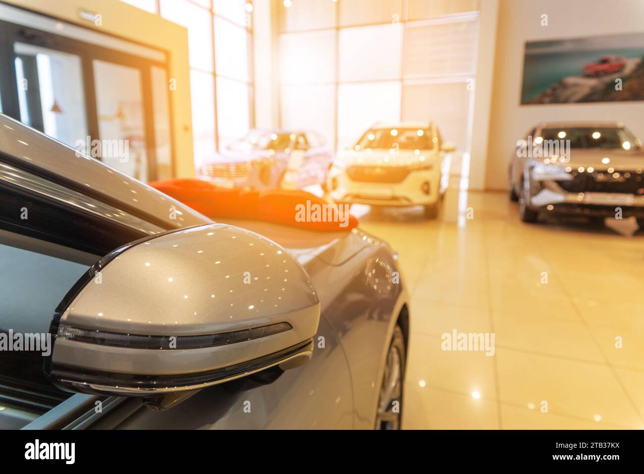 Blurred new car parked in modern showroom waiting for sales. Abstract ...