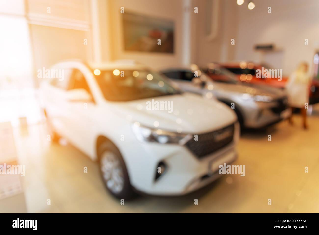 Blurred new car parked in modern showroom waiting for sales. Abstract ...