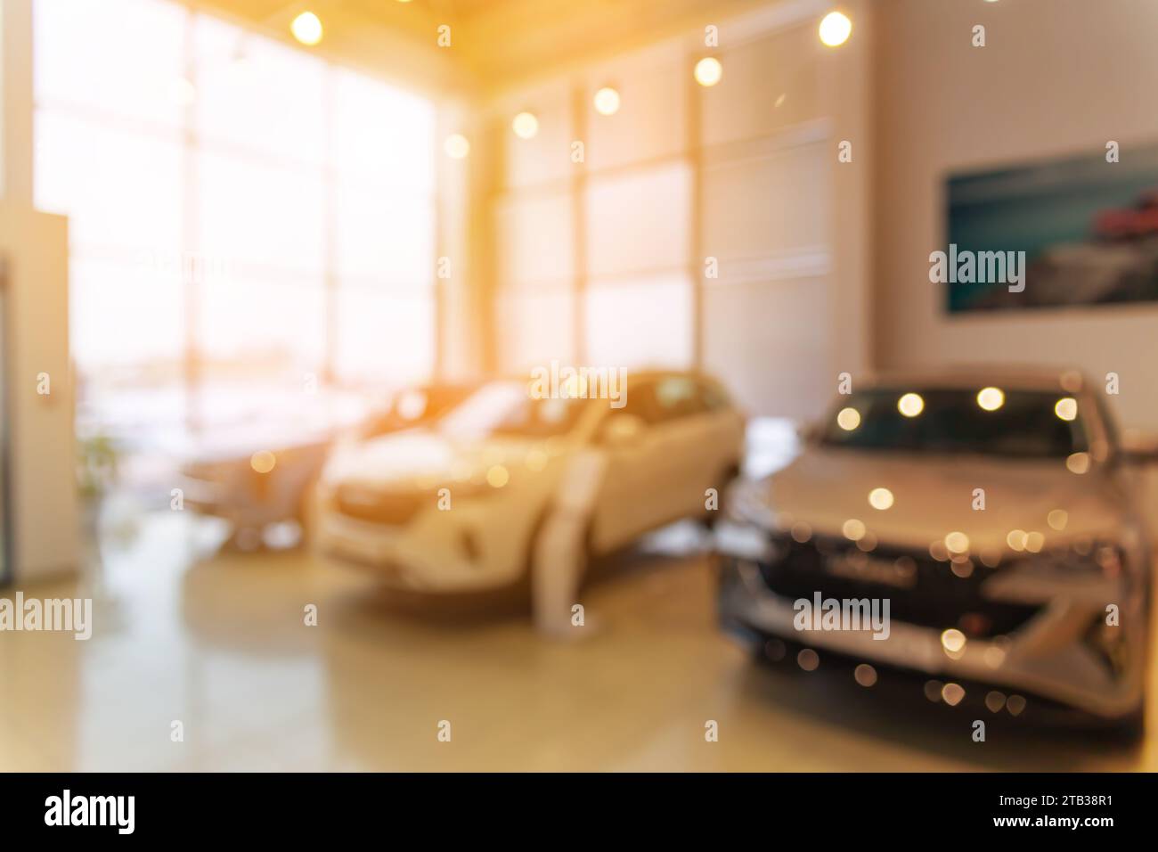 Blurred new car parked in modern showroom waiting for sales. Abstract ...
