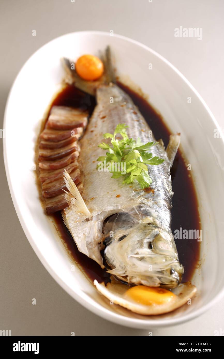 Steamed Topmouth culter fish with ham，Steamed white fish on a white ...