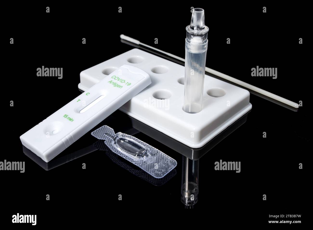 A coronavirus rapid test kit with a liquid vile and nasal swab in a ...