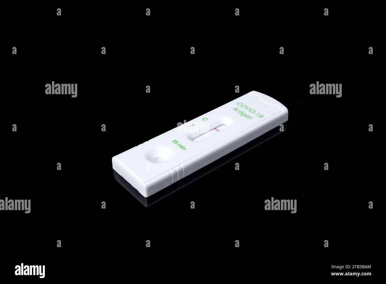 A COVID-19 rapid test displaying a negative test result on a black ...