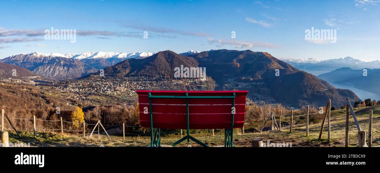 Big red bench on the alps of Lake Como Stock Photo - Alamy