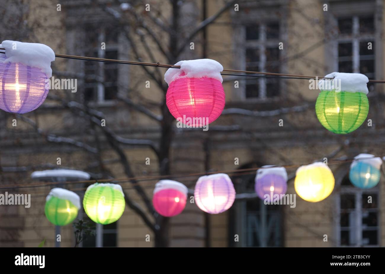 Leipzig, Germany. 04th Dec, 2023. Snow-covered lanterns light up in ...