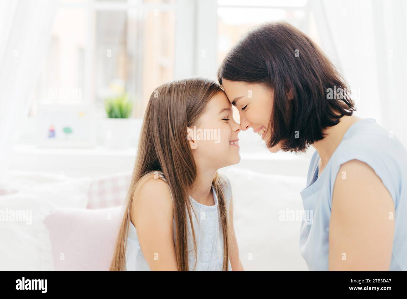 Affectionate mother and daughter touching noses in a gentle moment Stock Photo - Alamy