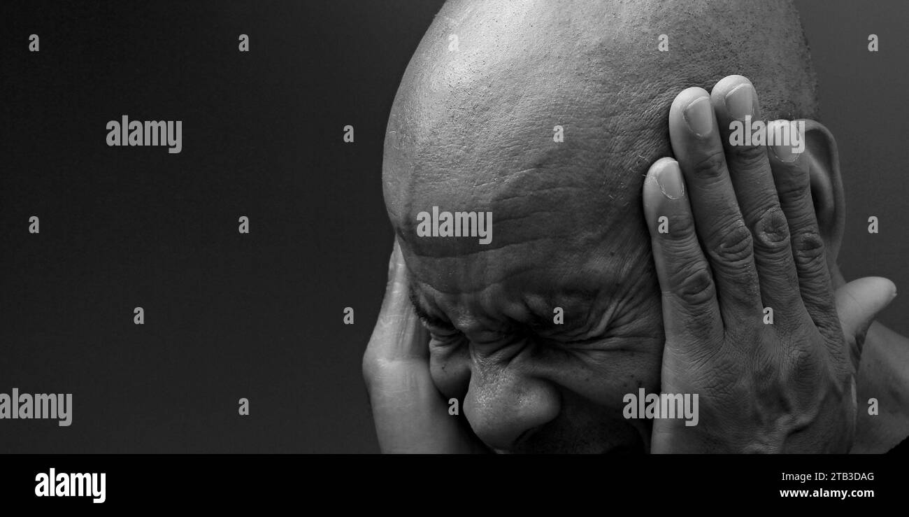 suffering from deafness and hearing loss on grey black background with ...