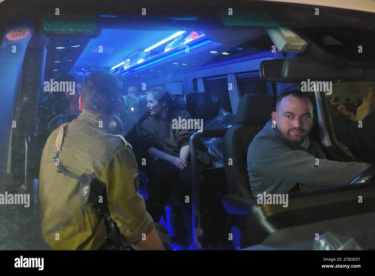 Newly released Israeli hostages sit in a van among soldiers as they ...