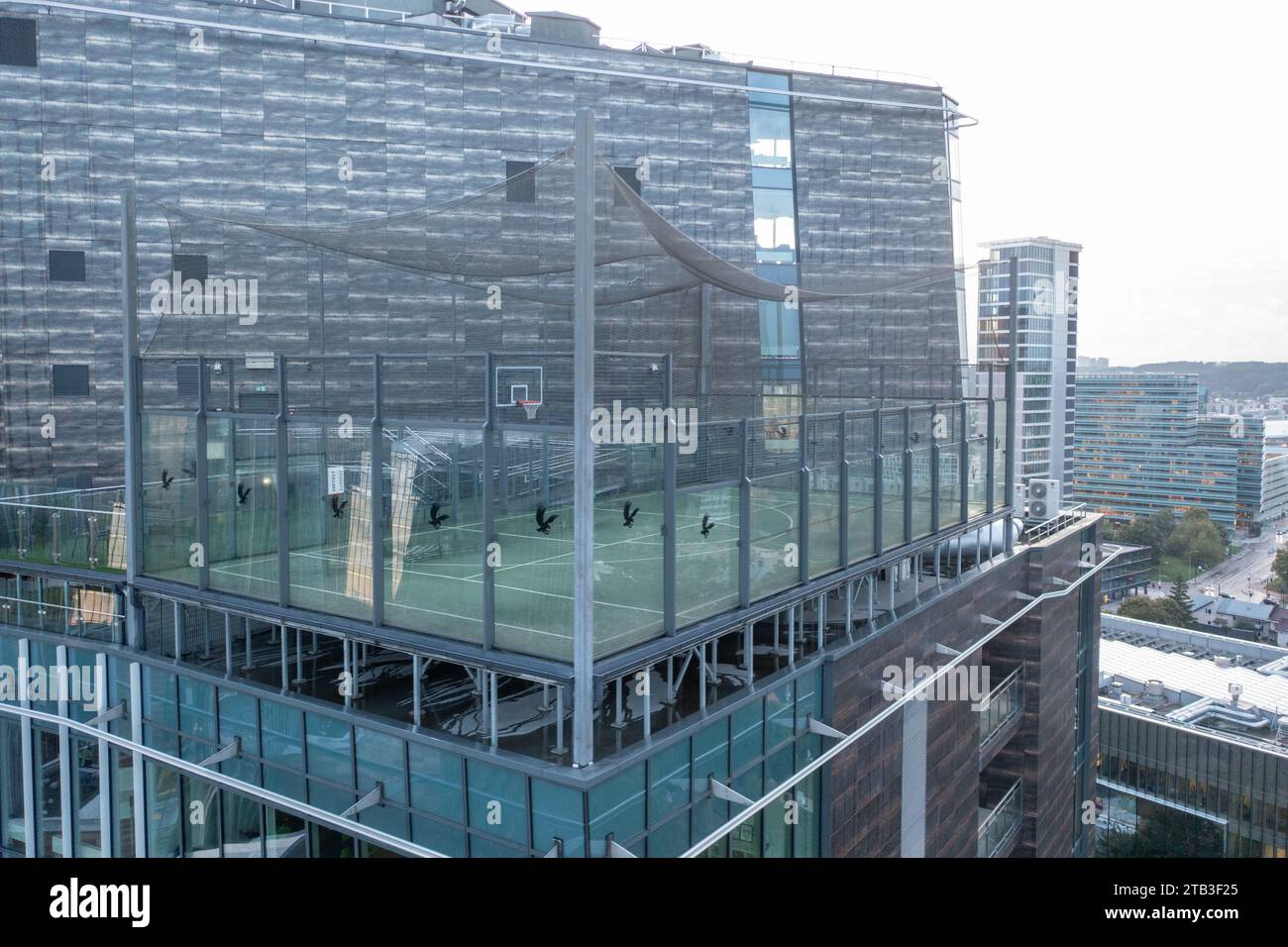Drone photography of basketball court on a skyscraper rooftop during ...