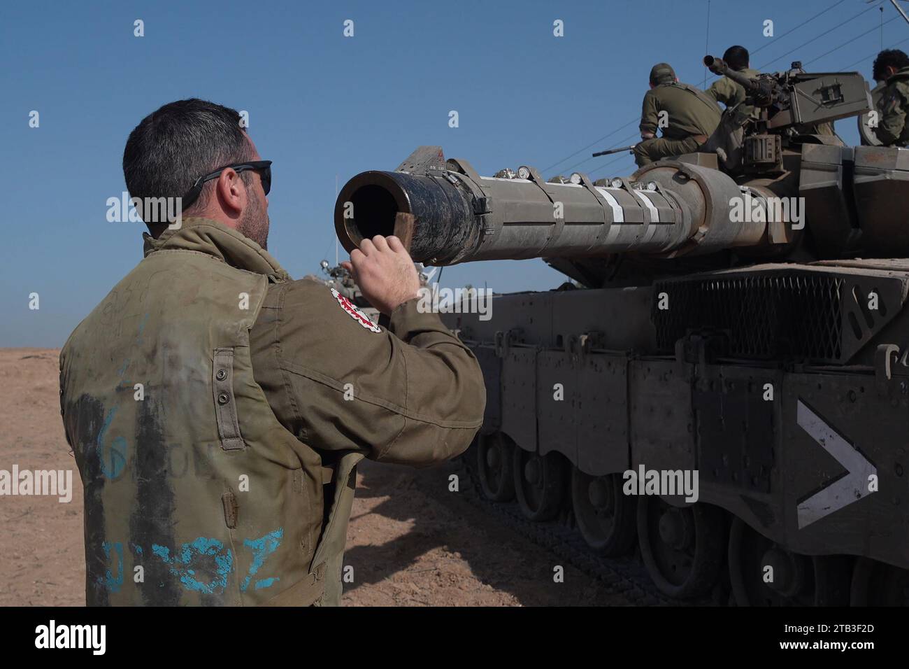An Israeli soldier cleans the canon of a tank at a position near the ...