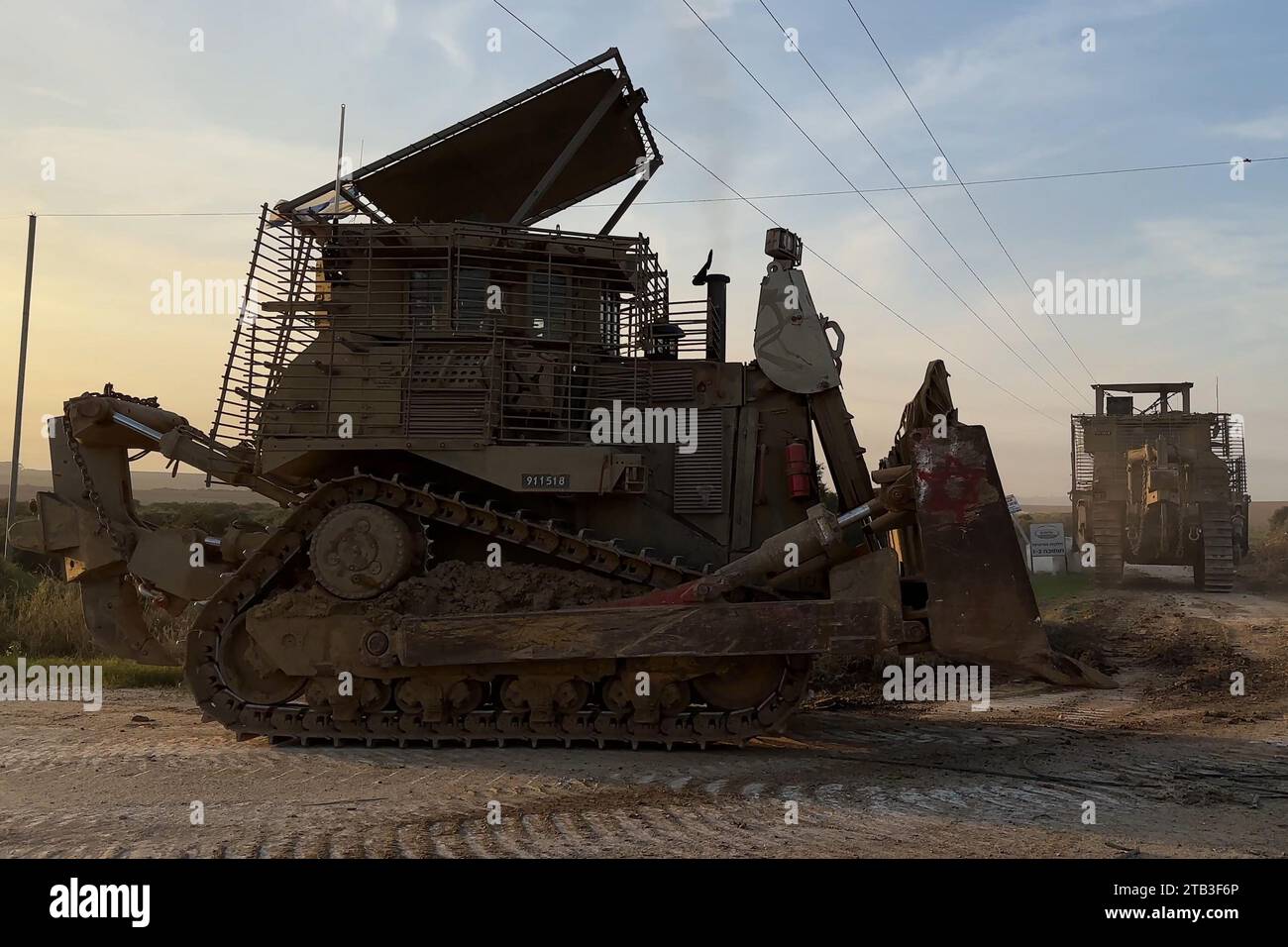 An Israeli D9 armored military bulldozer rolls near the border with the ...