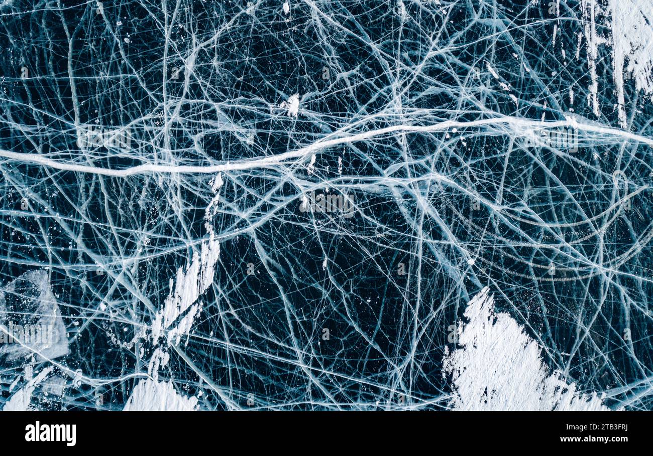 Aerial top down view on the blue cracked ice of the lake Baikal. Winter ...